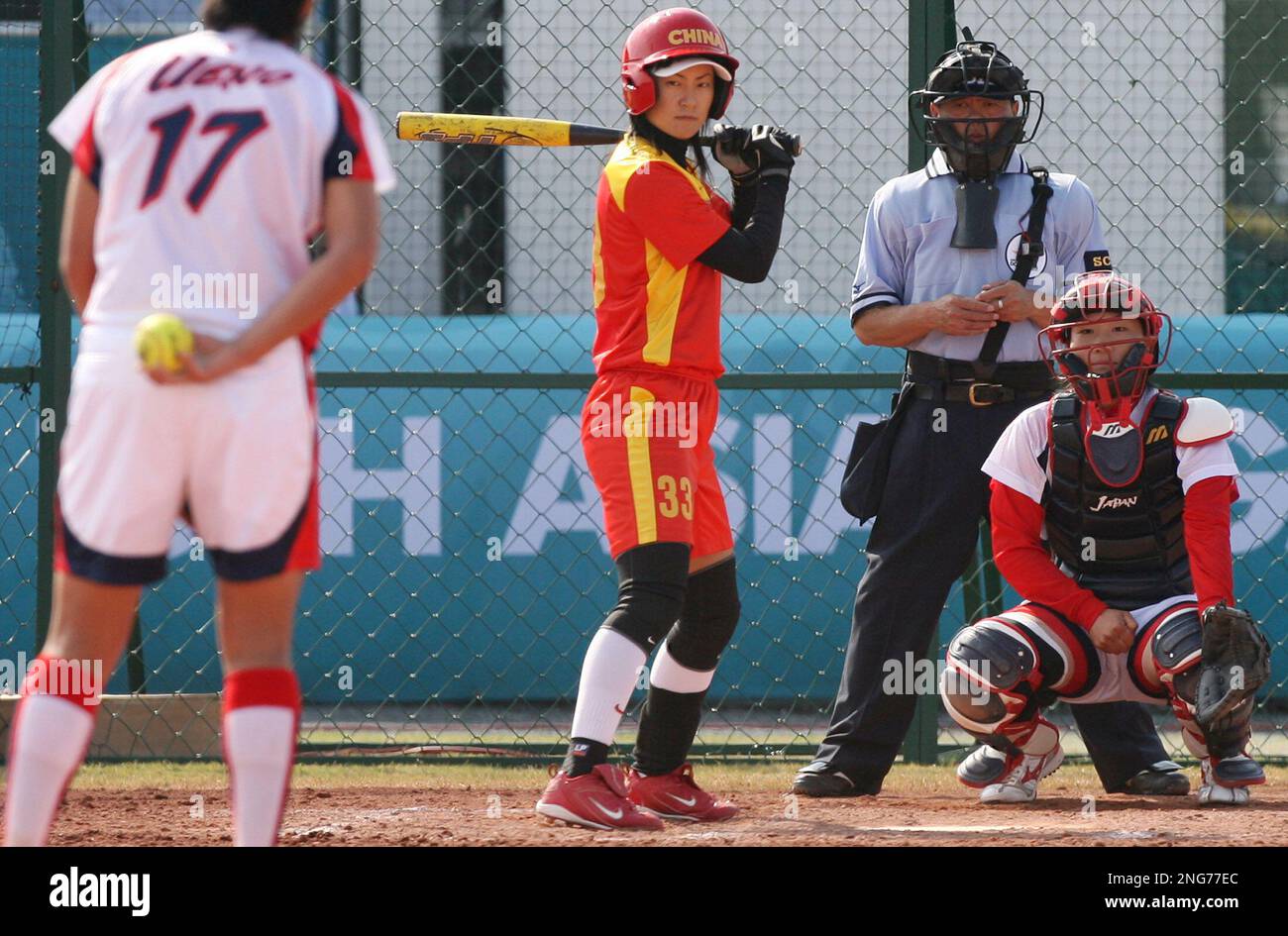 Xin Minhong of China watches Japanese pitcher Yukiko Ueno ready for a ...