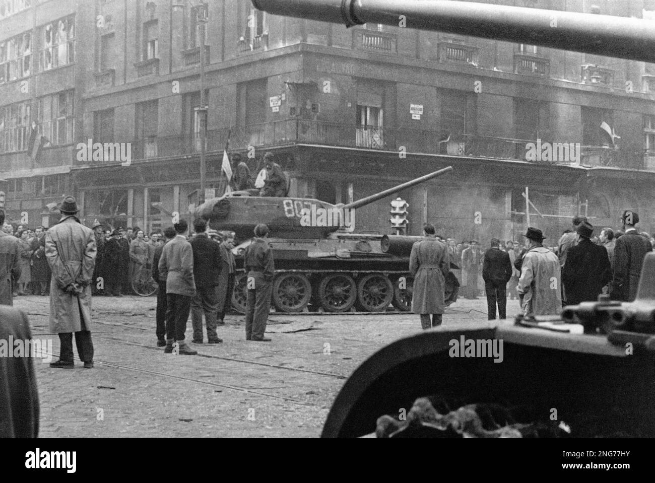 Hungarians approach a Russian tank flying the Hungarian flag outside ...