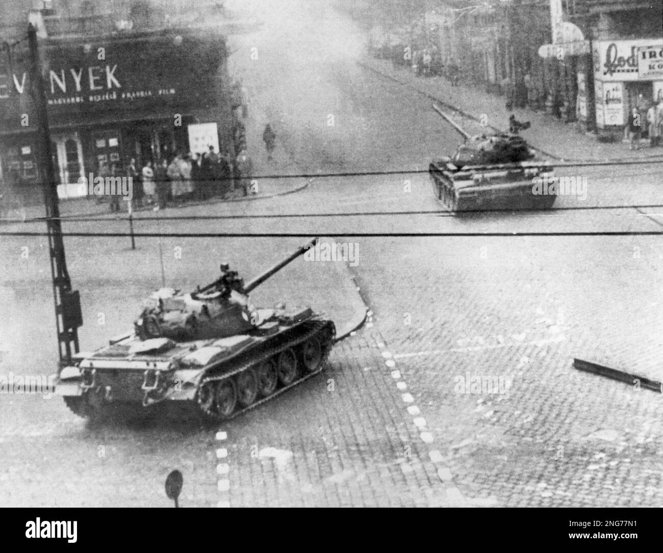 Soviet-built tanks wheel into action in a smoke-filled Budapest street ...