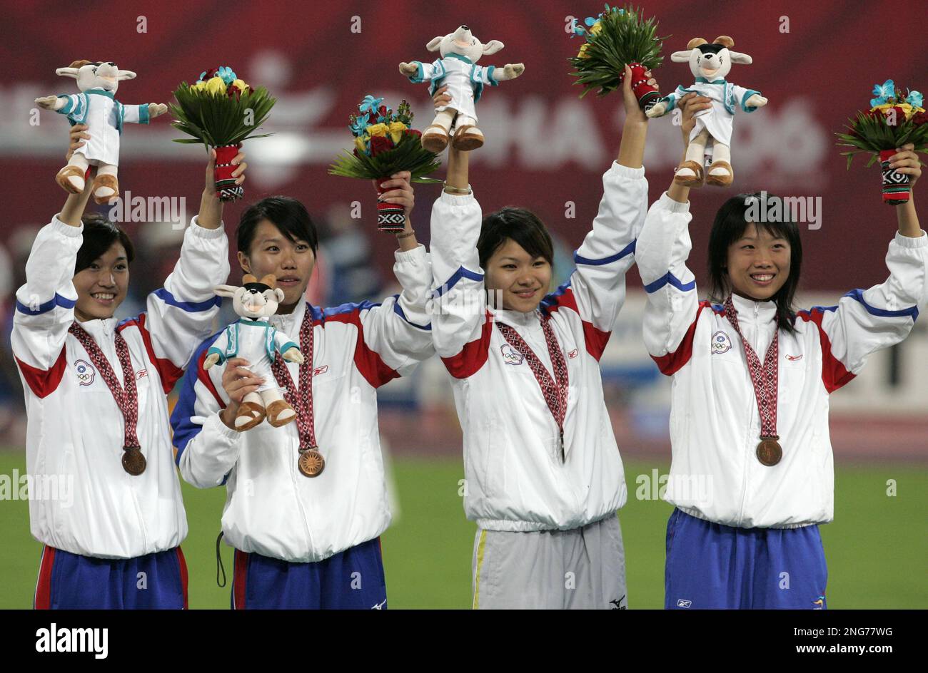 The Taiwnese team celebrate holding the the bronze medals they won in ...