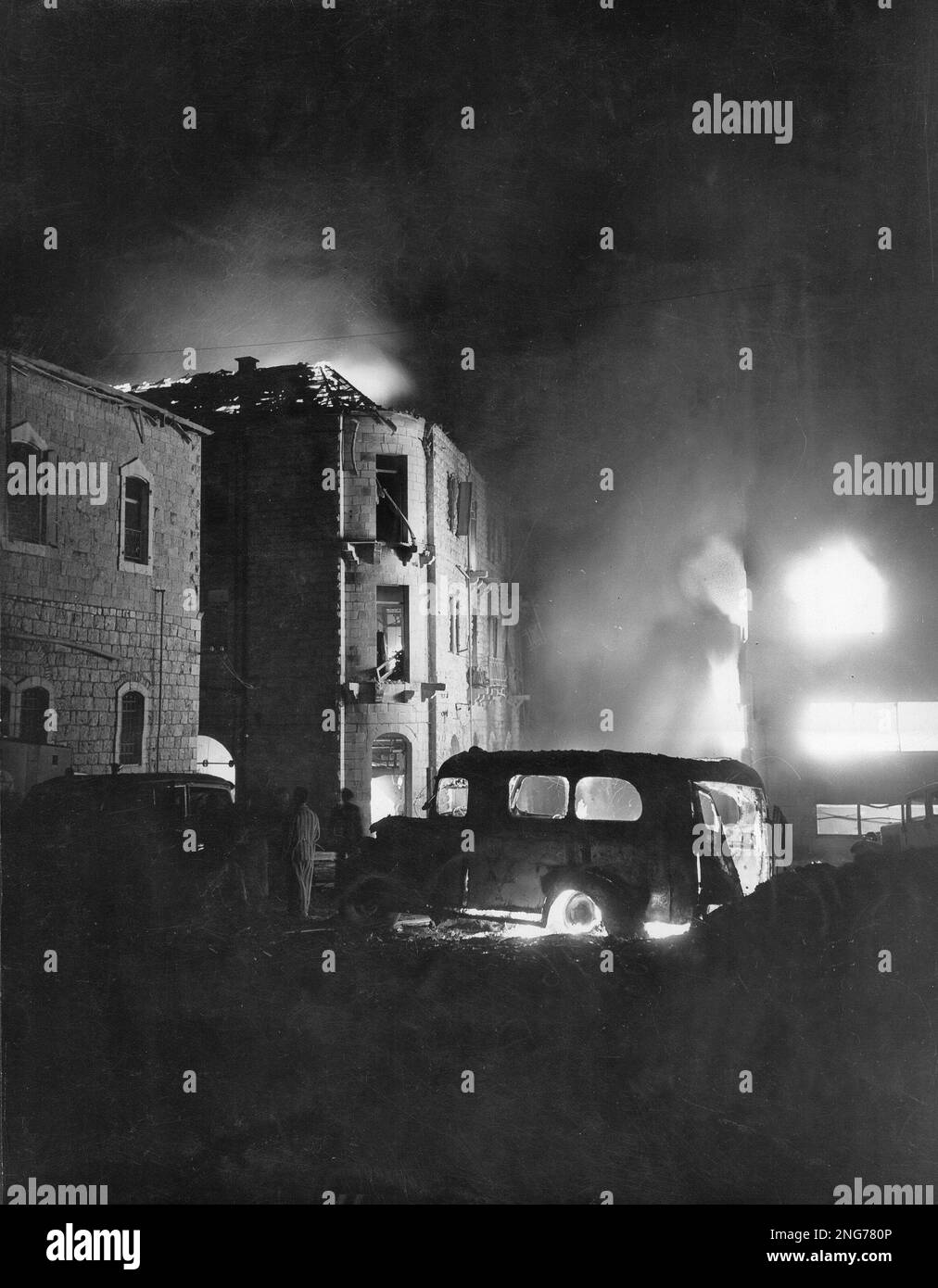Buildings of the Palestine Post on fire after a bomb had exploded, in ...