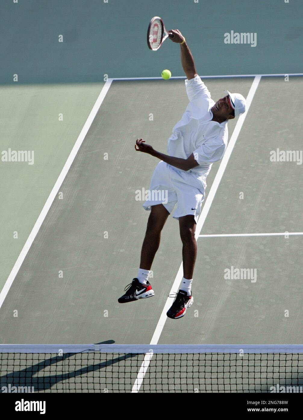India's Mahesh Bhupathi smashes the ball while playing against Cecil ...