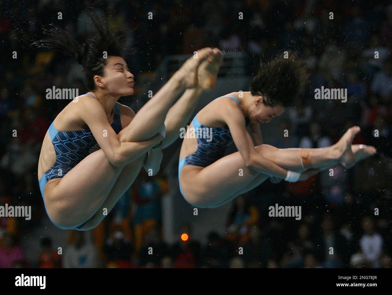 Chinese women divers Guo Jingjing and Li Ting perform their dive at the ...