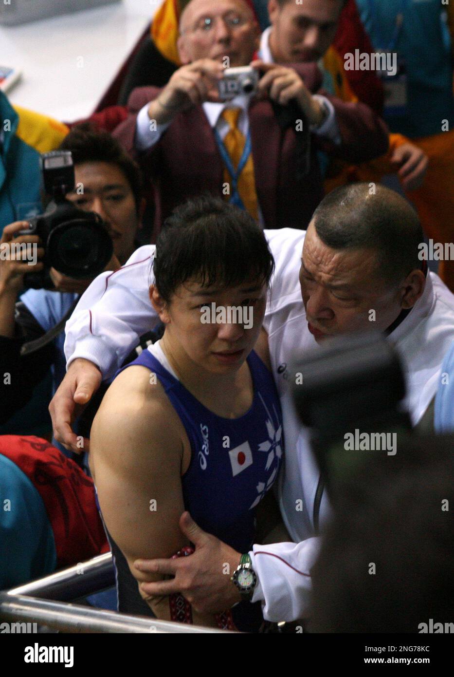 Japan's Kyoko Hamaguchi is comforted by her father Animal Hamaguchi ...