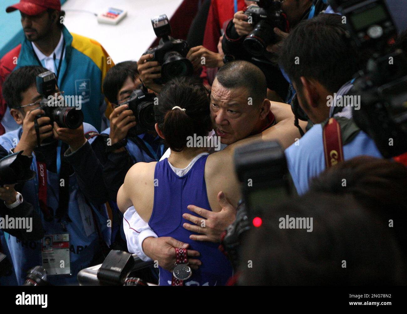 Japan's Kyoko Hamaguchi, back to camera, is comforted by her father ...