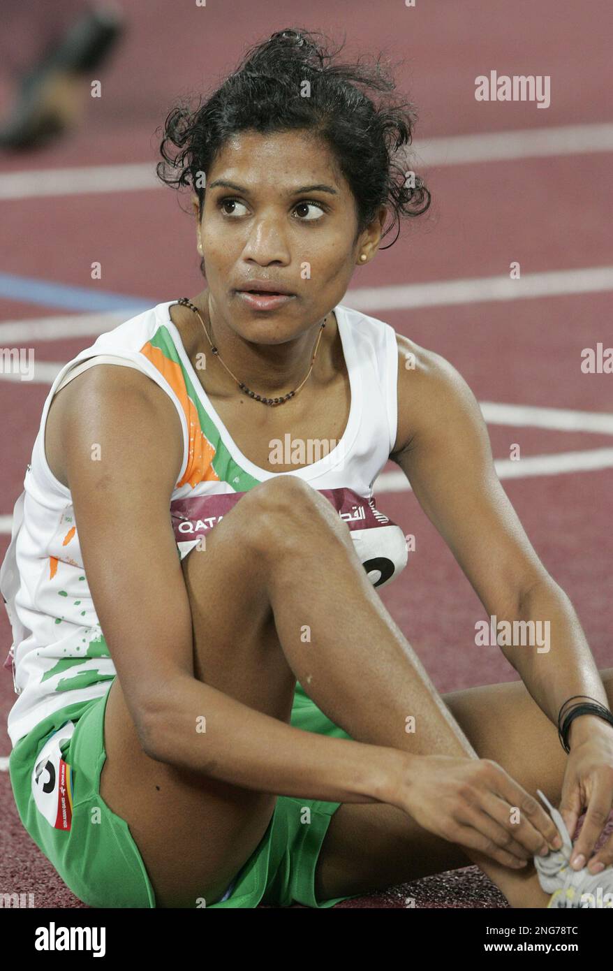India's P. Jaisha Orchatteri sits on the track after taking the bronze ...