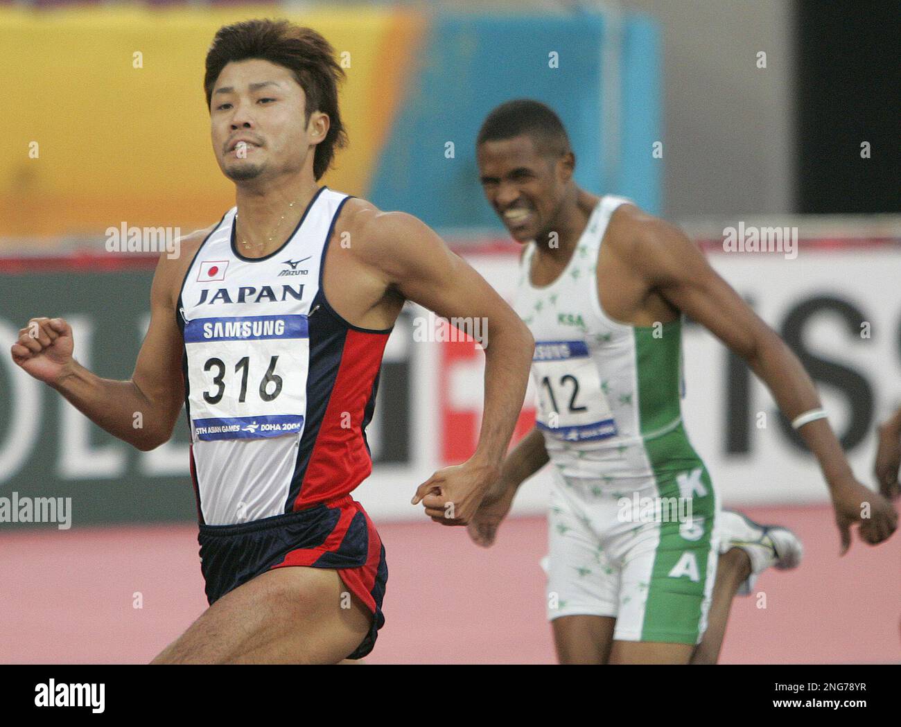 Japan's Shingo Suetsugu, left, crosses the line to win the gold medal ...