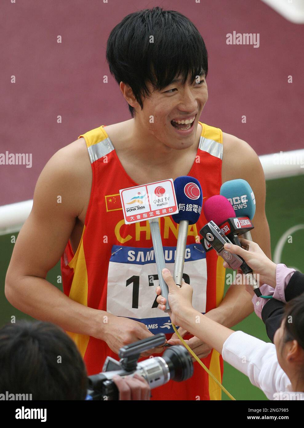 China's Liu Xiang smiles as he is interviewed after winning his Men's ...