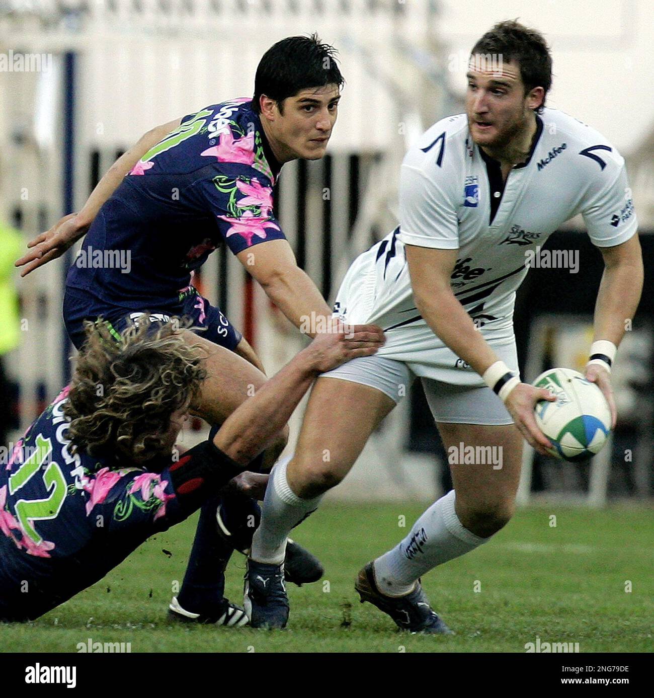 Mirco Bergamasco, left, David Skrela, center, of Stade Francais, try to ...