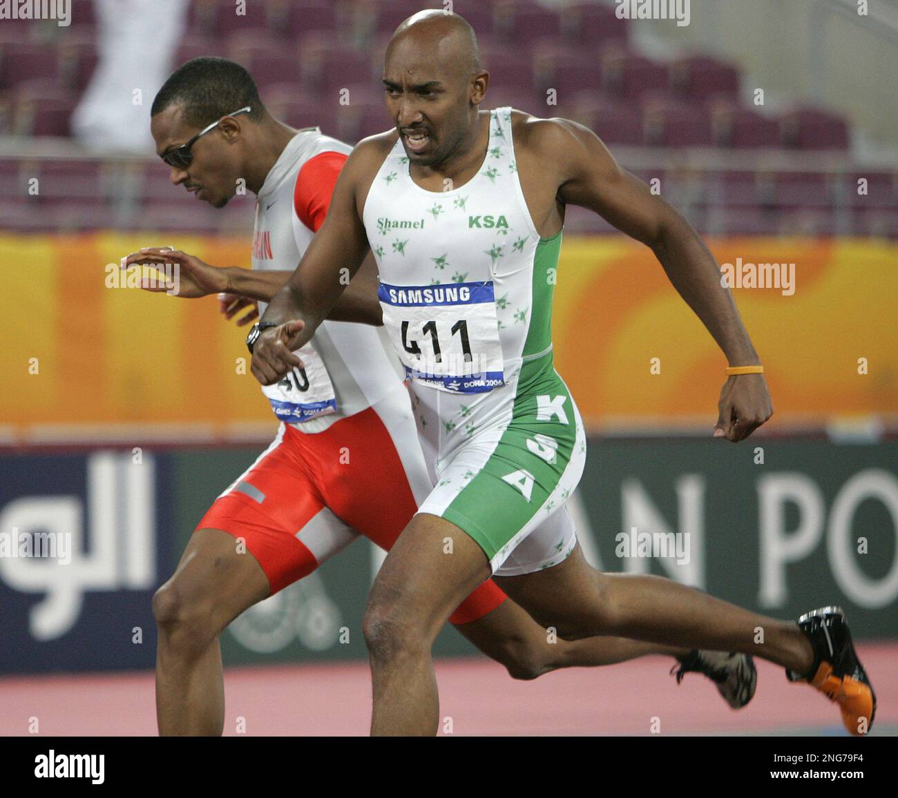 Saudi Arabia's Hamdan Awdah Al Bishi, right, crosses the line just ...