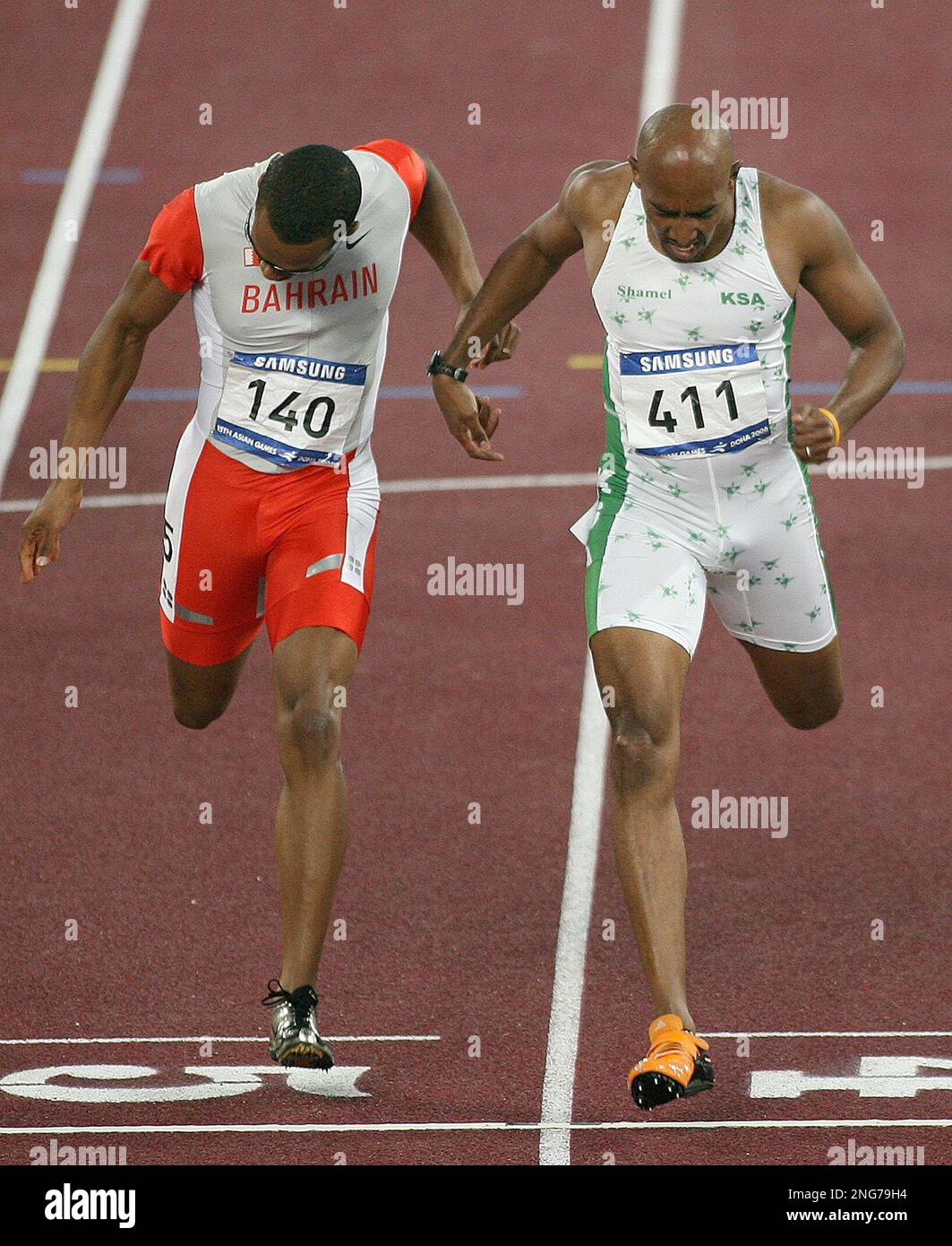 Saudi Arabia's Hamdan Awdah Al Bishi, right, crosses the line just ...