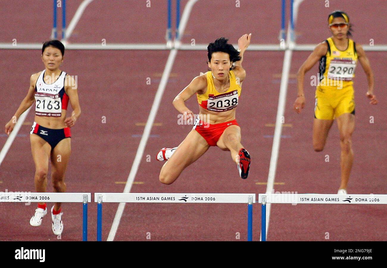 China's Huang Xiaoxiao clears the final hurdle on her way to winning ...