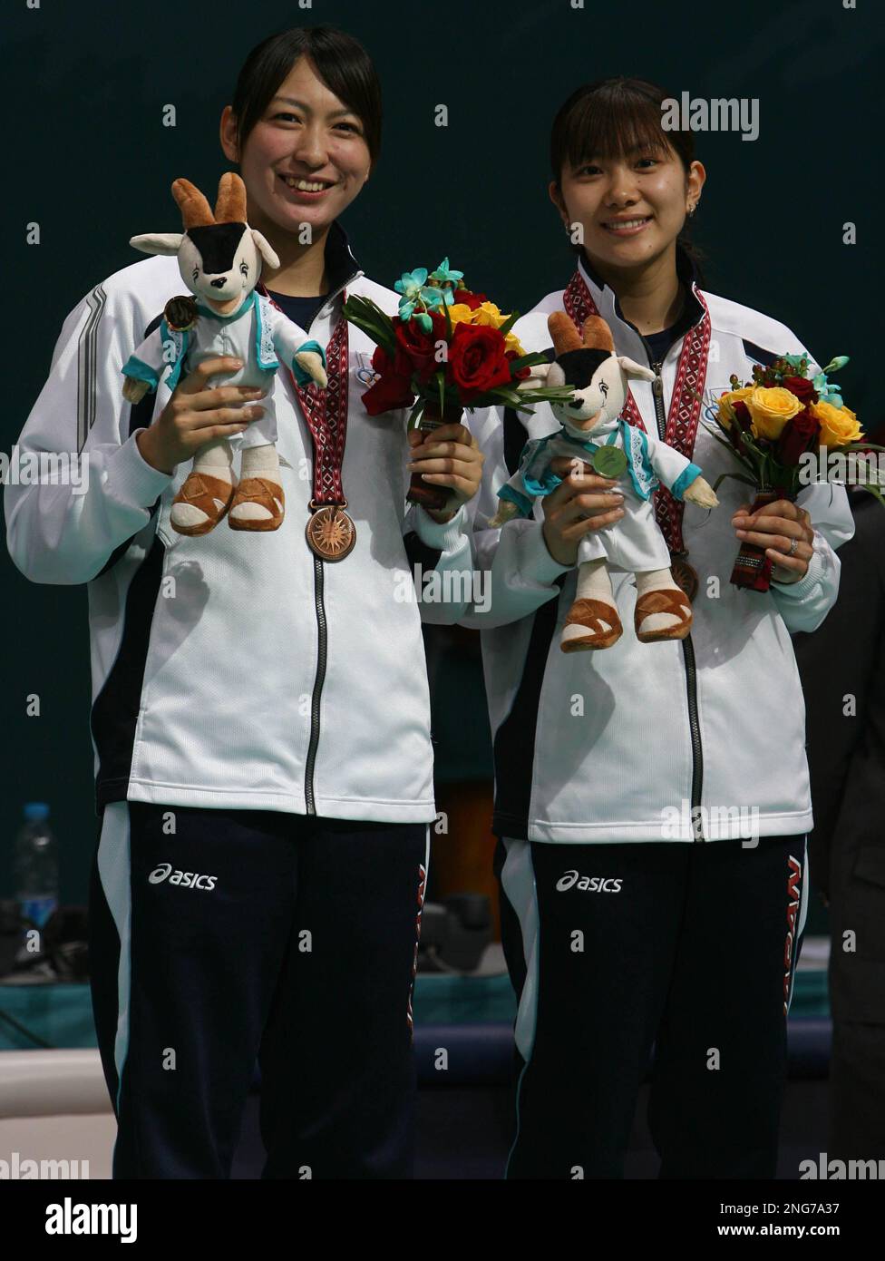 Japan's Reiko Shiota, right, and Kumiko Ogura smile after being awarded ...