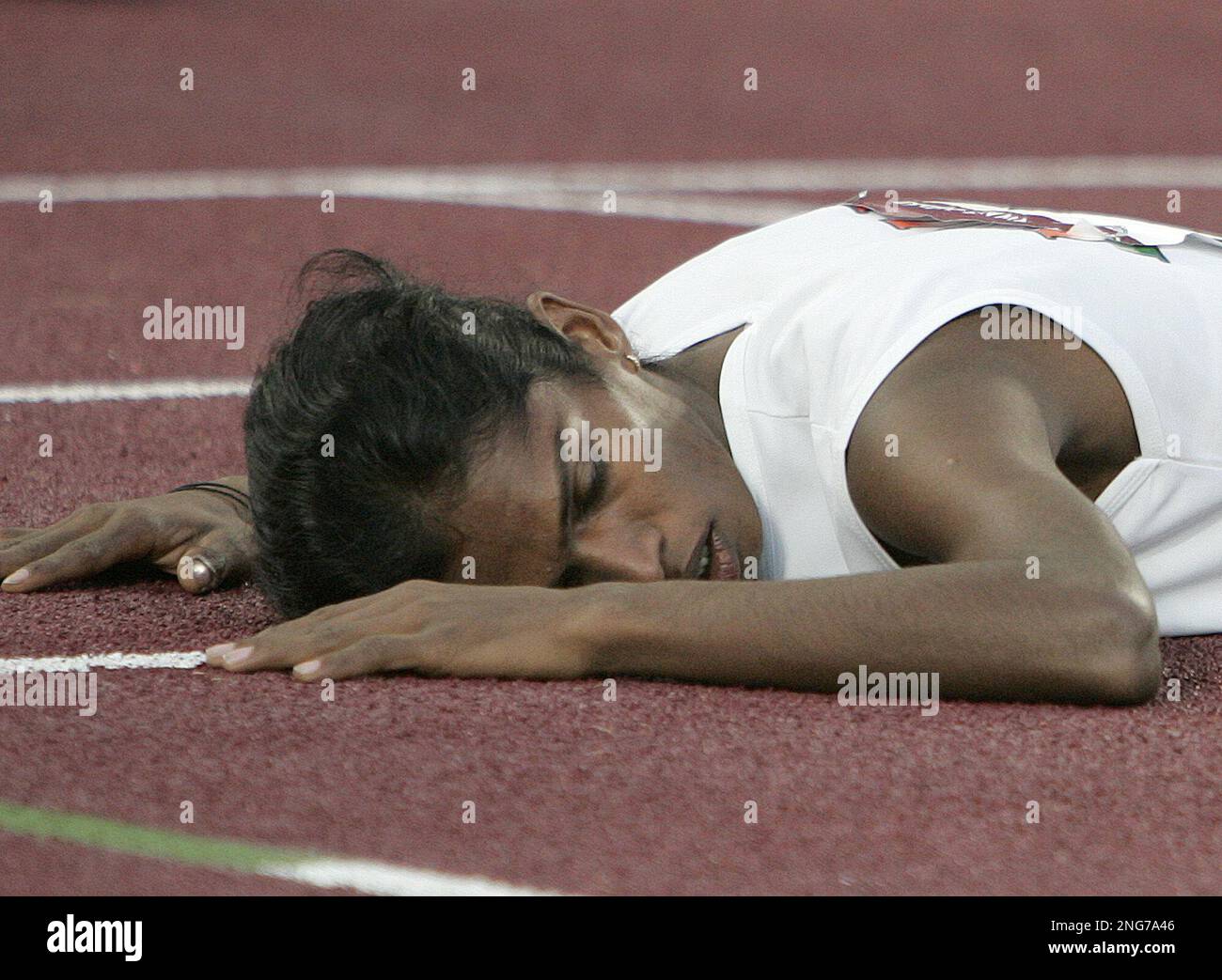 India's Santhi Sounarajan lays on the track after collapsing after ...