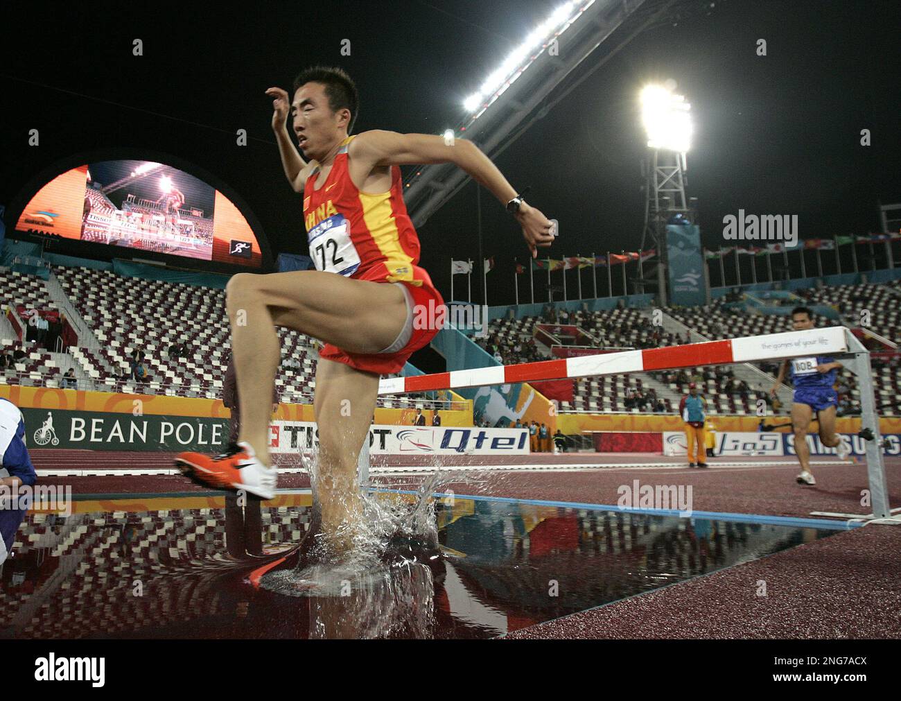China's Lin Xiangqian makes the water jump on his way to winning the ...