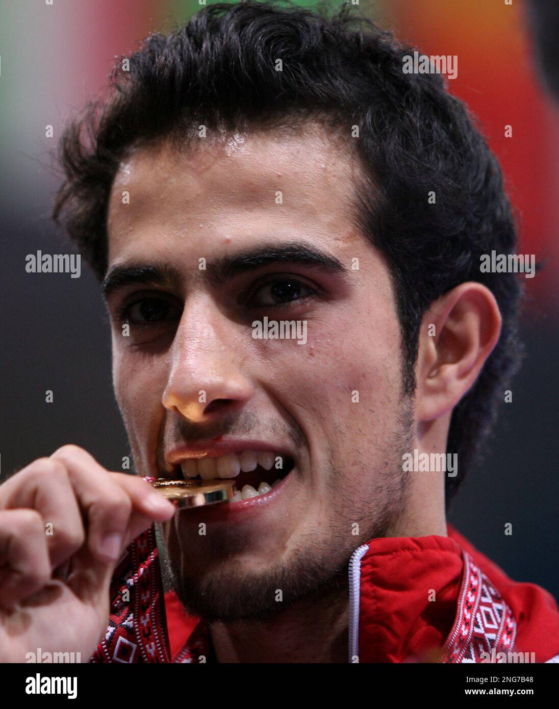Mohammad Al Bakhit of Jordan bites his gold medal for the Asian Games ...