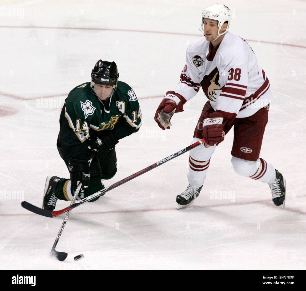 Dallas Stars center Stu Barnes (14) falls to the ice as he tries to ...