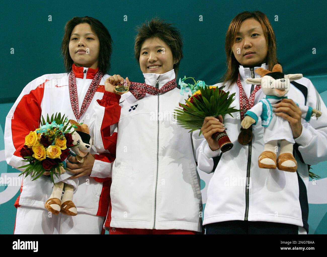 Singapore's Li Tao, center, the gold medal winner, is flanked at left ...