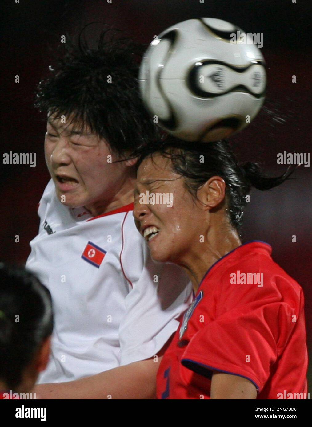 Hwang Bo-ram of South Korea, right, heads the ball with Jong Pok Sim of ...
