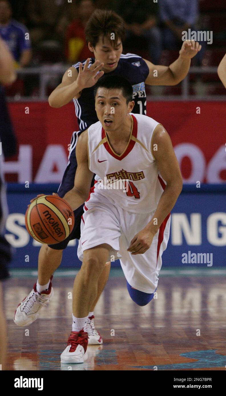 China's Hu Xuefeng dribble away Taiwan's guard during a basketball ...