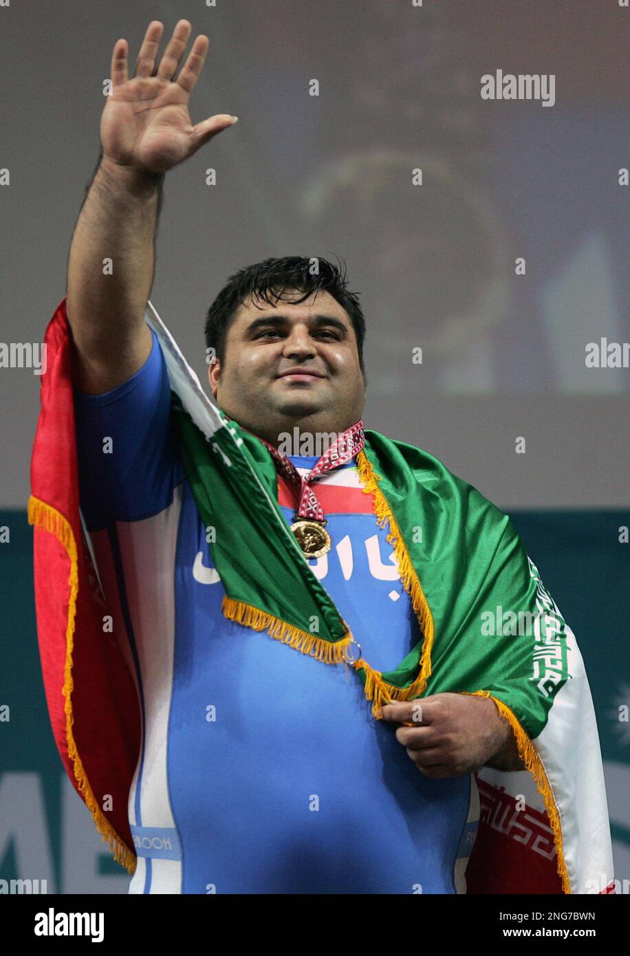 Wearing Iranian national flag, Iran's Hossein Reza Zadeh waves on the ...