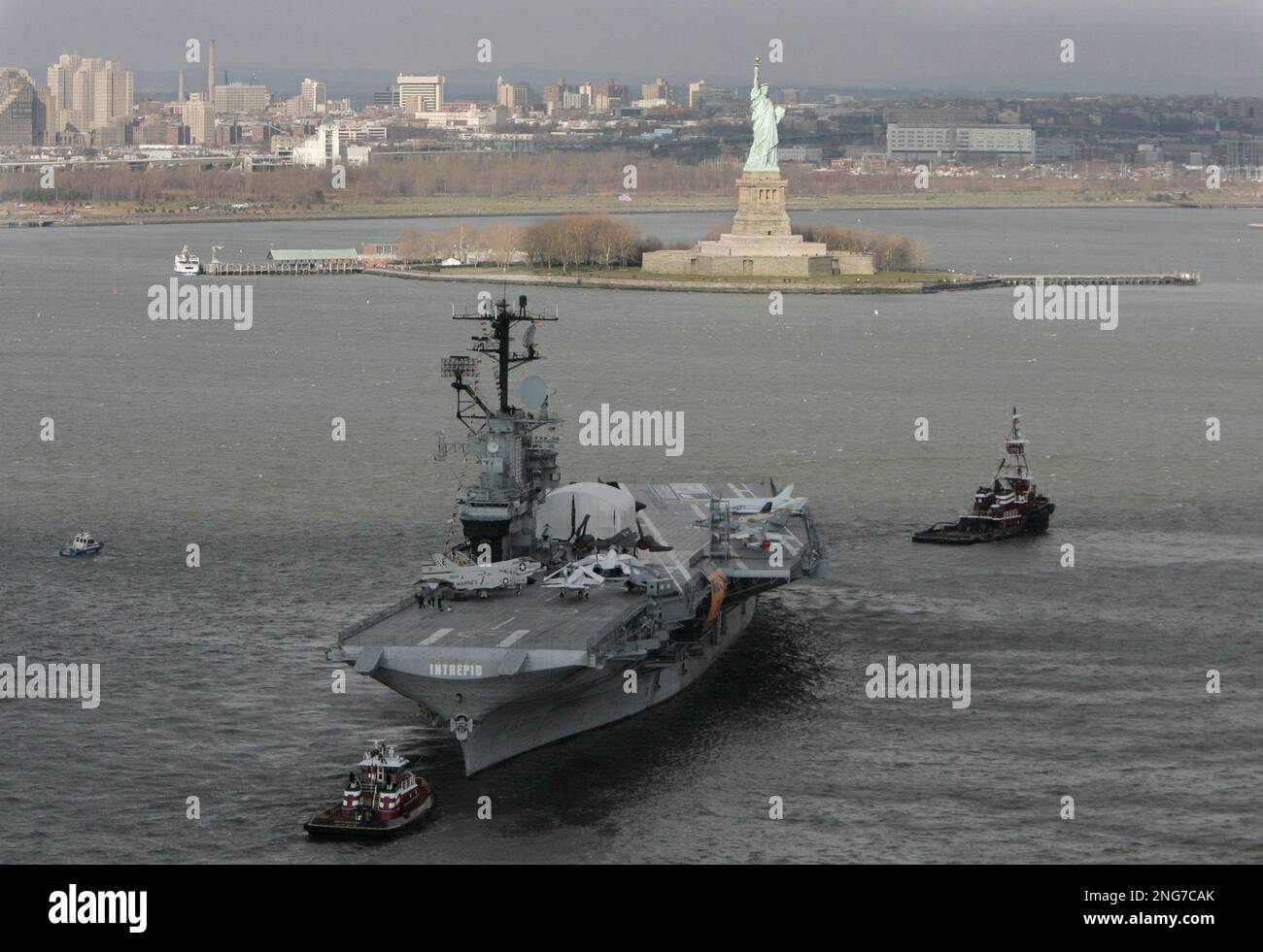 The USS Intrepid aircraft carrier is moved down the Hudson River ...
