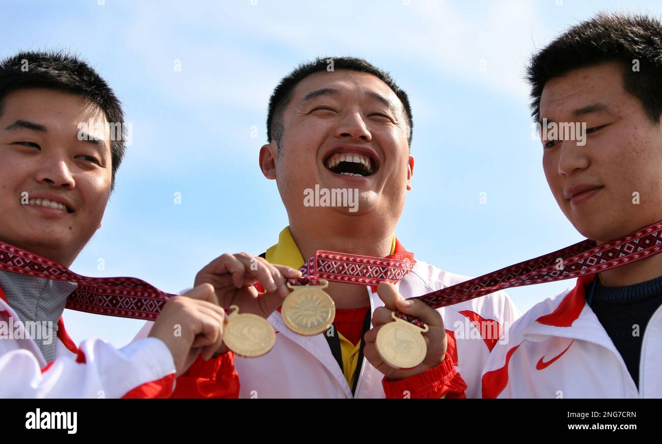China's Xu Kun, Tan Zongliang and Pan Wei , from left, show their gold ...