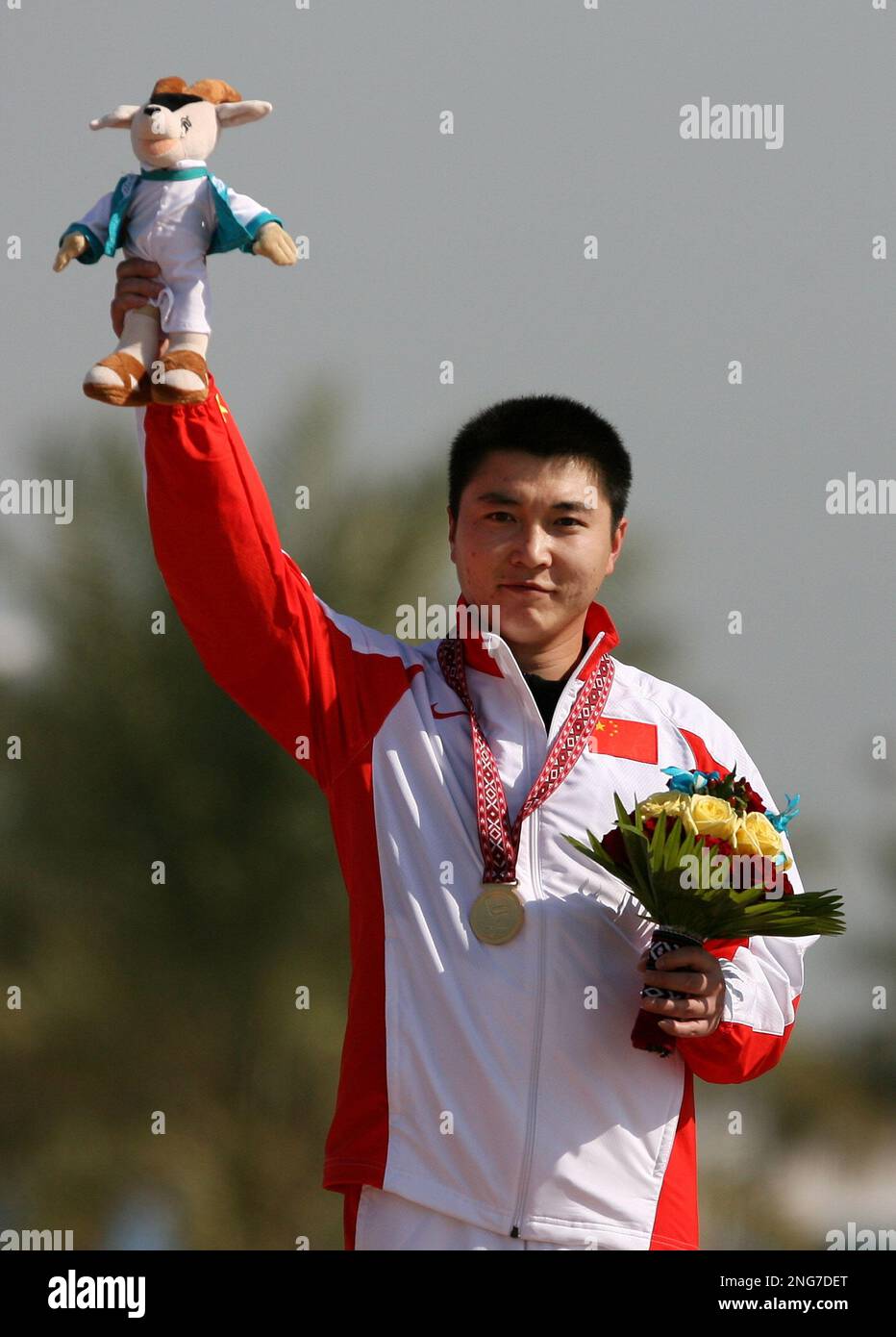 Liu Gang of China waves a mascot, Orry, after receiving a gold medal ...