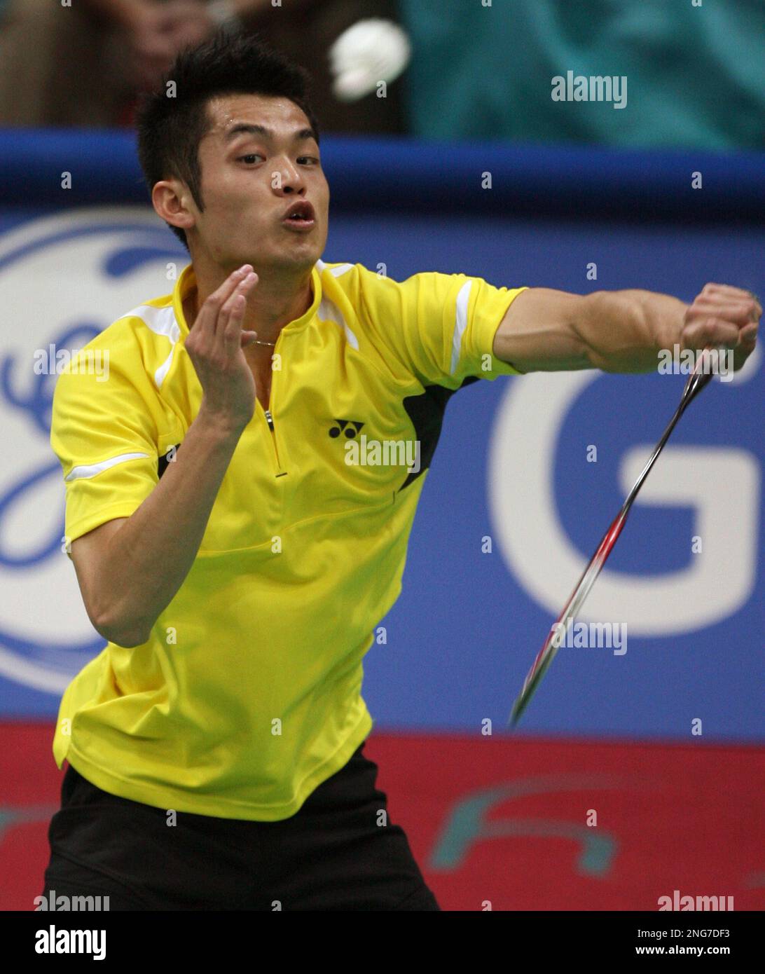 Lin Dan of China hits the shuttlecock during the Asian Games badminton men's team semifinals ...