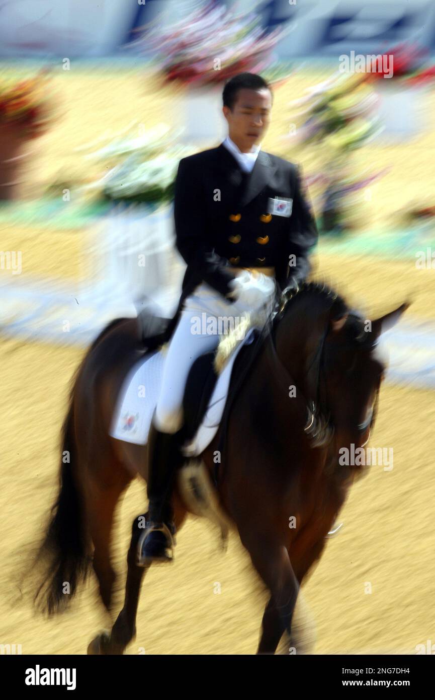 South Korea's Kim Dong-seon rides Pleasure 18, a 13-year-old gelding, performs during the ...