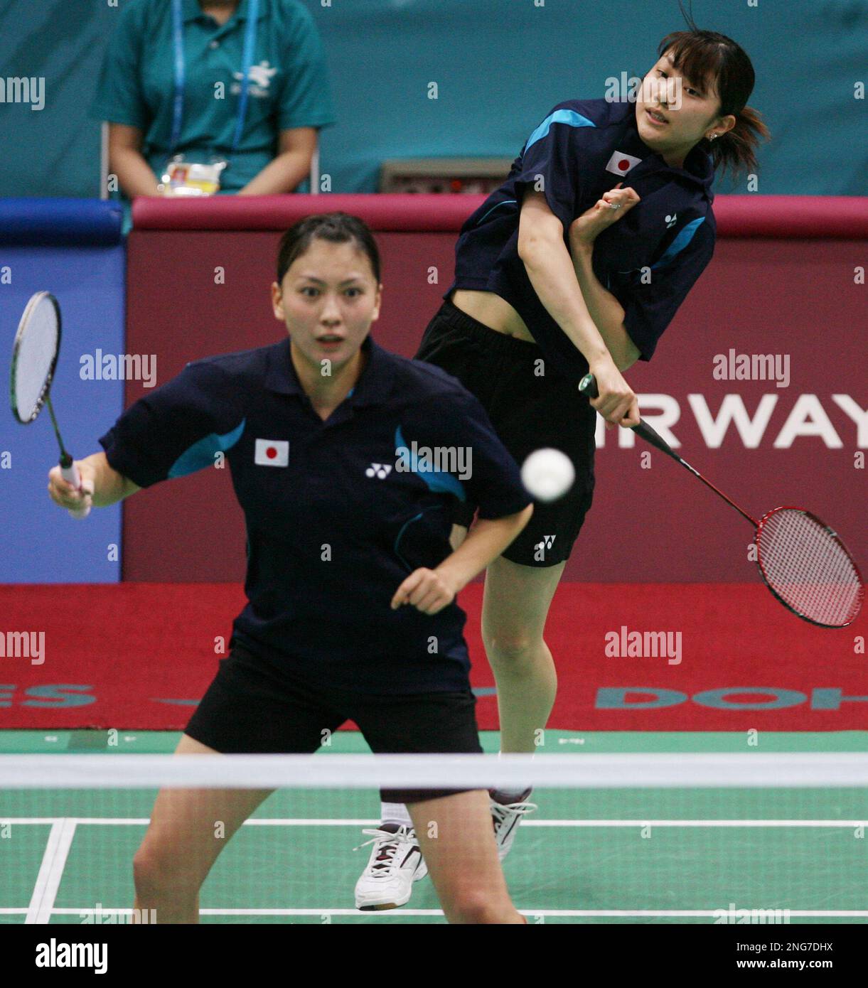 Japan's Reiko Shiota, back, returns the shuttlecock as Kumiko Ogura ...