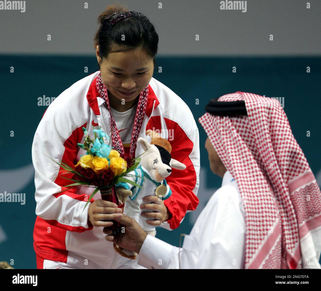 China's Yanqing Chen is presented with Orry, a mascot for the 15th ...