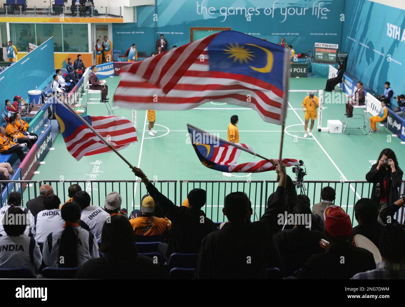 Malaysian fans wave Malaysia's national flags during the Asian Games ...