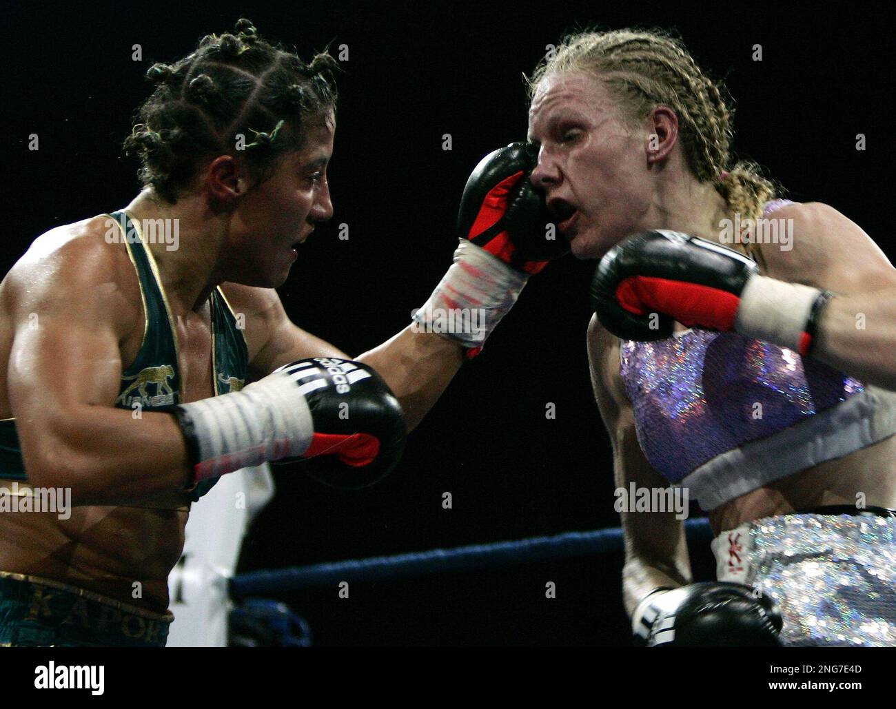 French female boxer Myriam Lamare, left, lands a left to the face of ...