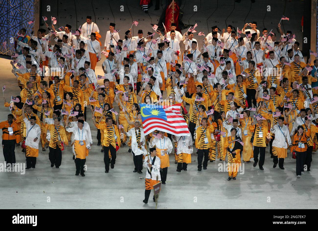 The Malaysian team enter the arena during the Opening Ceremony of the ...