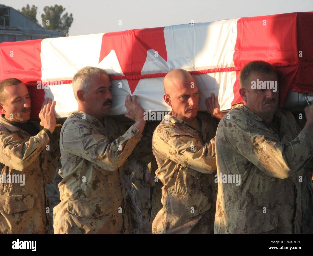 Soldiers carry a coffin of a Canadian soldier during a ramp ceremony at ...