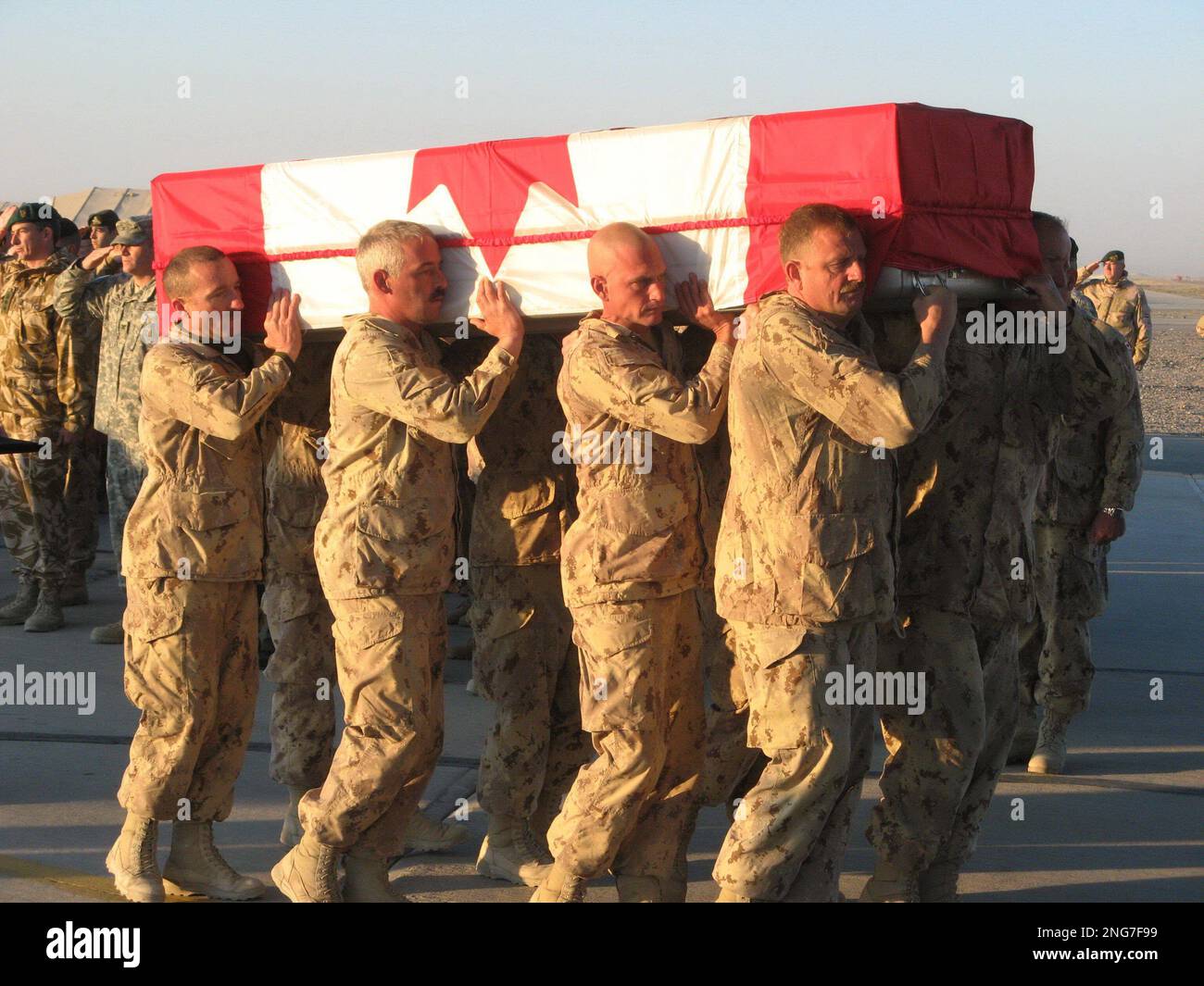 Soldiers carry a coffin of a Canadian soldier during a ramp ceremony at ...
