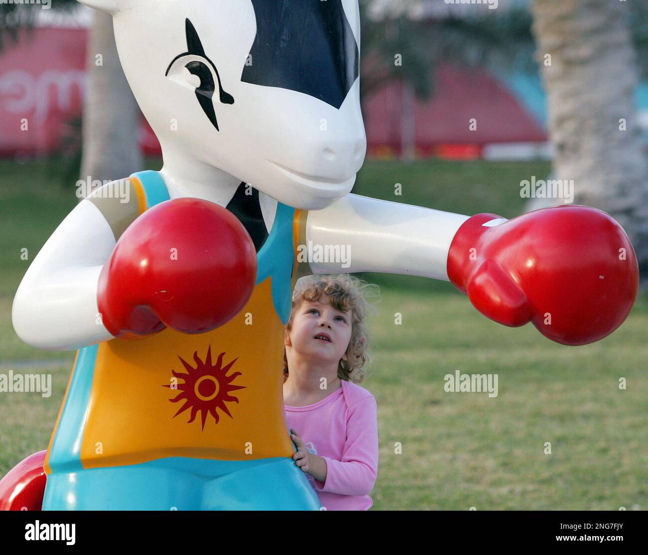 A young girl plays near a model of Asian Games mascot 'Orry', a Qatari ...