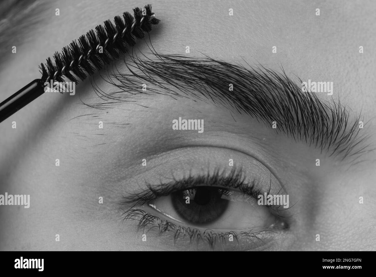 Eyebrow makeup. Beauty model shaping brows with brow pencil closeup ...