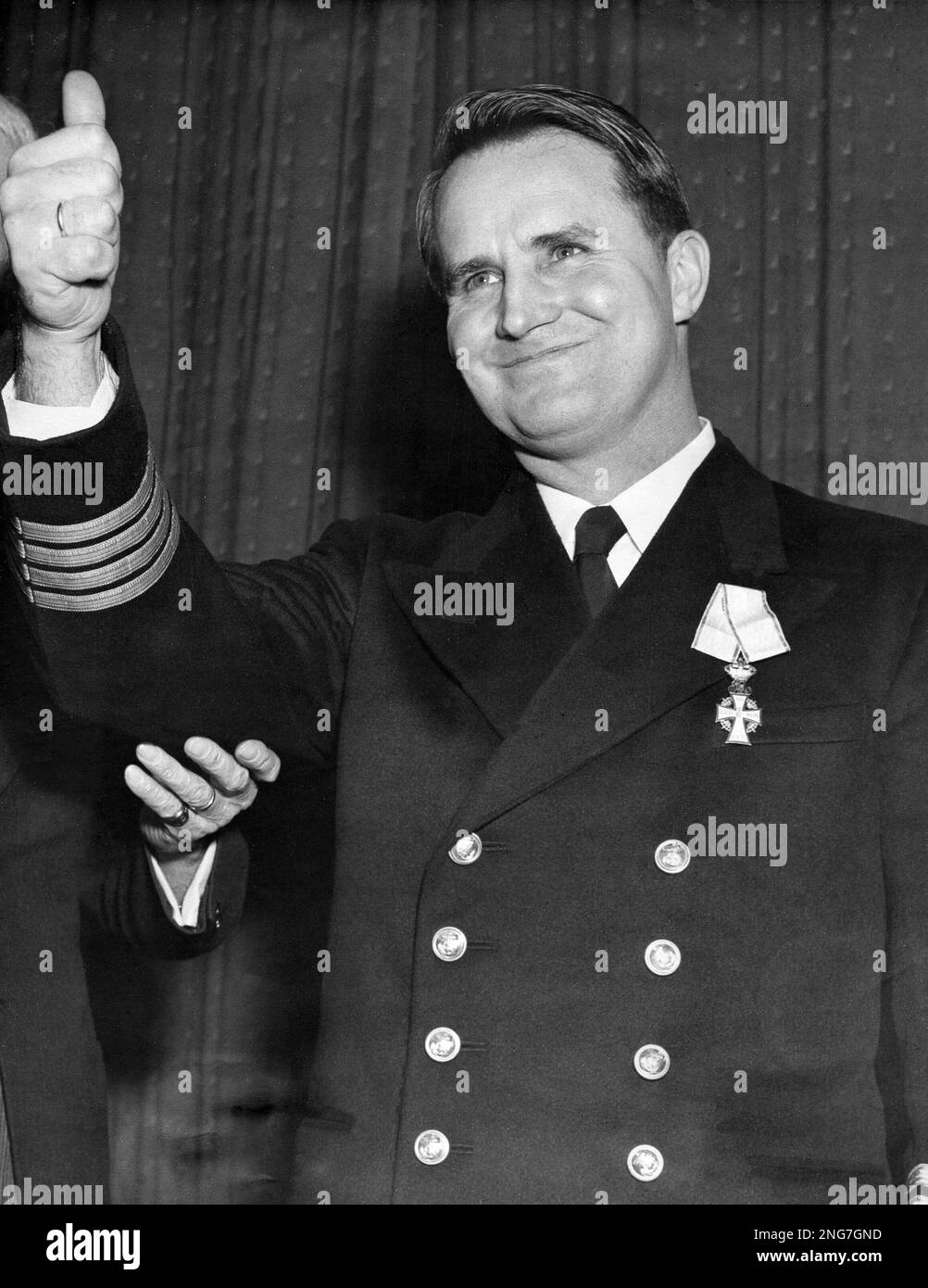 Capt. Kurt Carlsen gives a thumbs up after receiving the insignia of ...