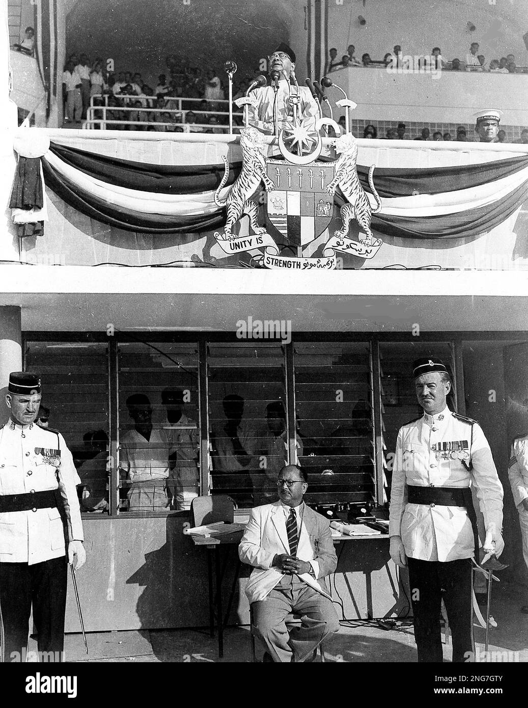 Chief Minister of Malaya Tunku Abdul Rahman, top, delivers an address ...
