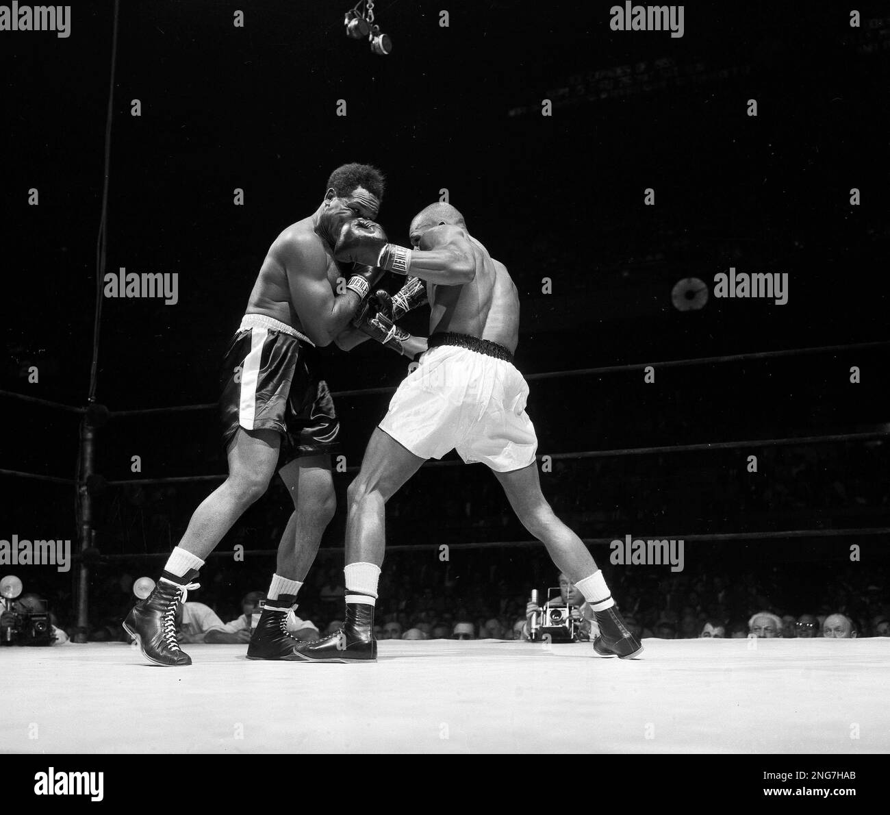 Harold Johnson, right, scores with a left to the face of defending ...