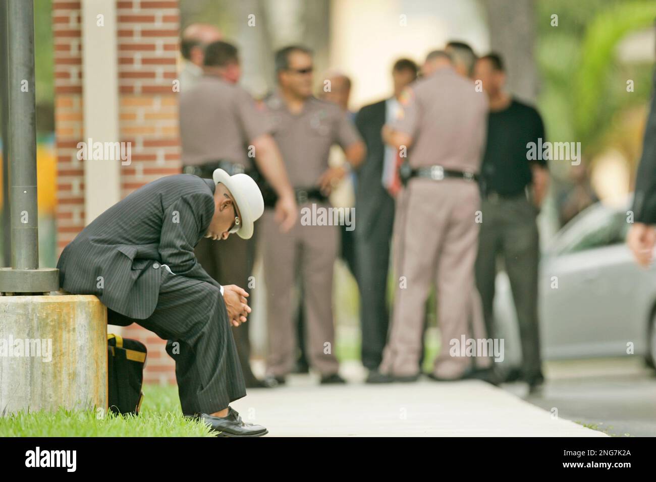 An man sits outside the church, one week after Miami defensive lineman ...
