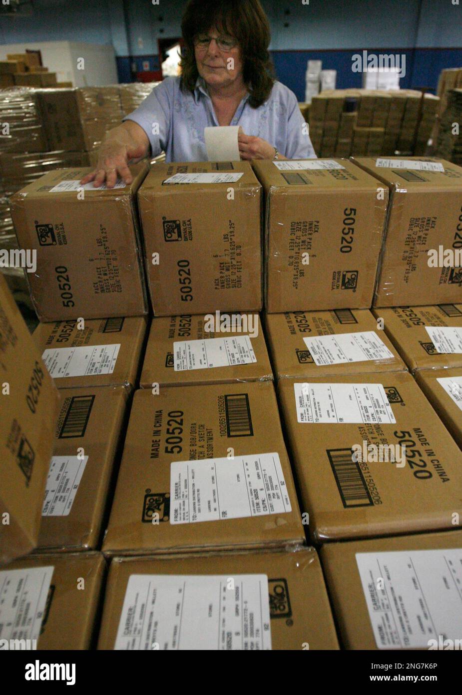 Sandy Gordon places labels on Etch A Sketch boxes in a warehouse at The ...