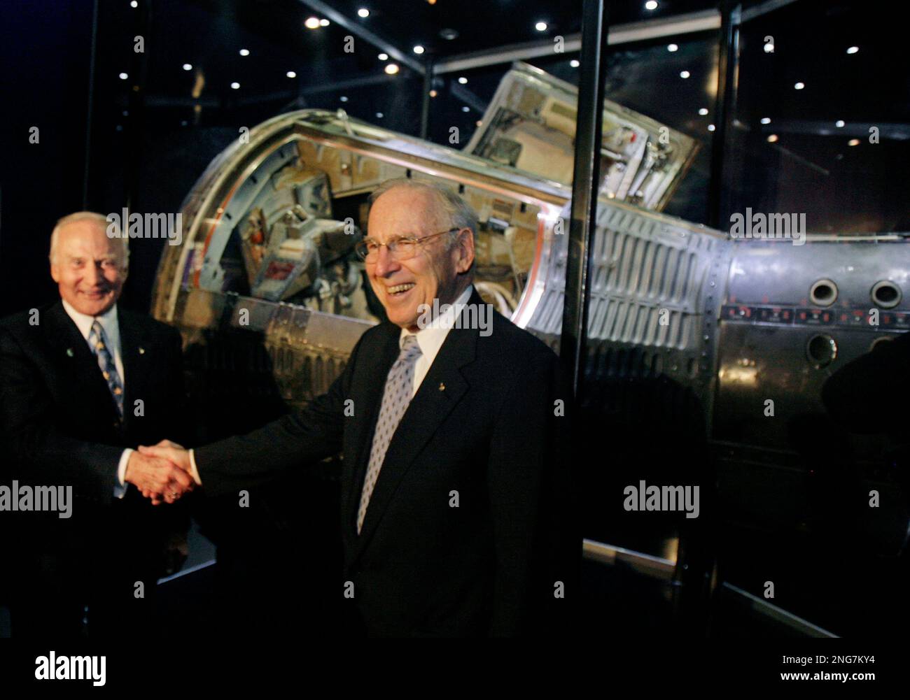 NASA astronauts Buzz Aldrin, left, and Jim Lovell shake hands in front ...