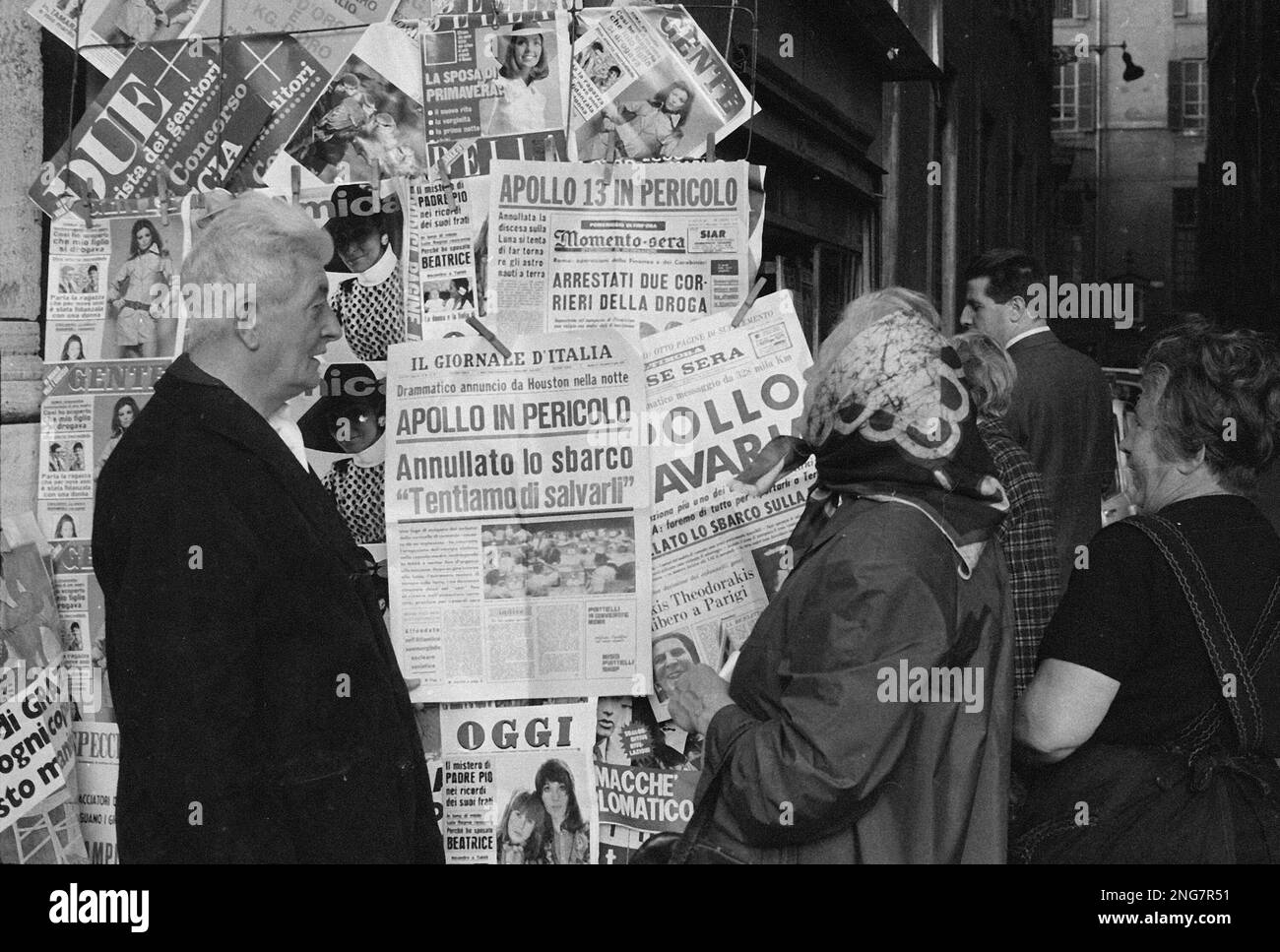 People in Rome look at newspapers April 14, 1970 headlining trouble ...
