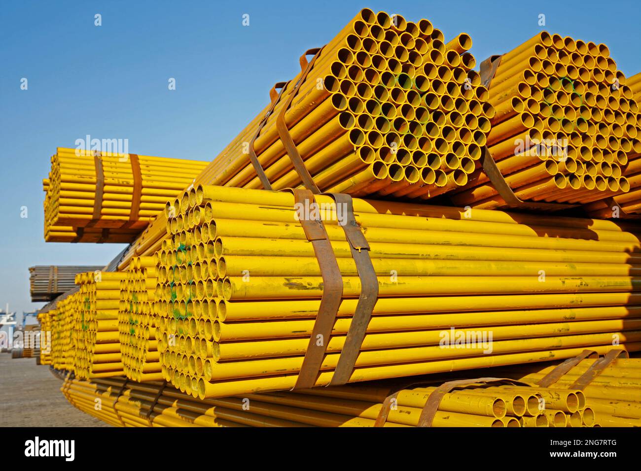 Yellow stacked steel pipe Stock Photo - Alamy