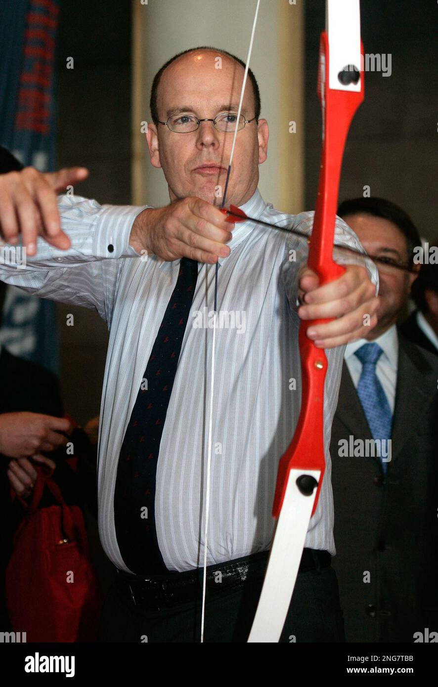 Prince Albert of Monaco prepares to shoot with a bow and arrow during ...
