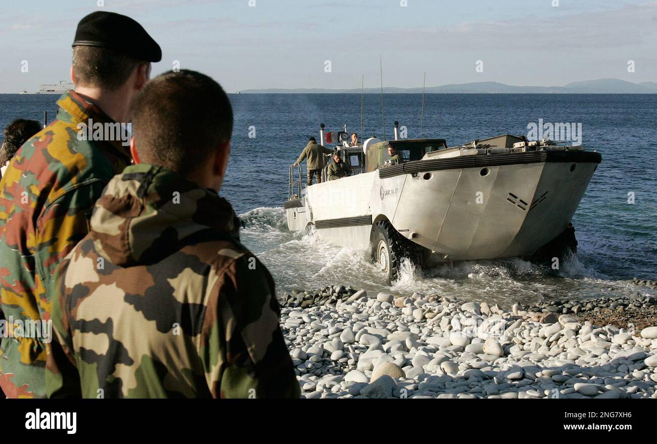 Two French soldiers look at a Larc 15, an amphibious vehicle of the ...