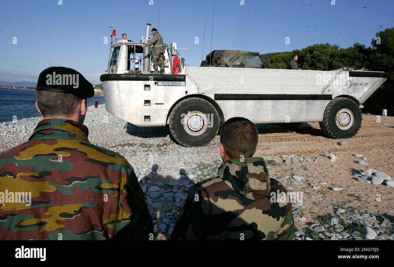 Two French soldiers look at a Larc 15, an amphibious vehicle of the ...